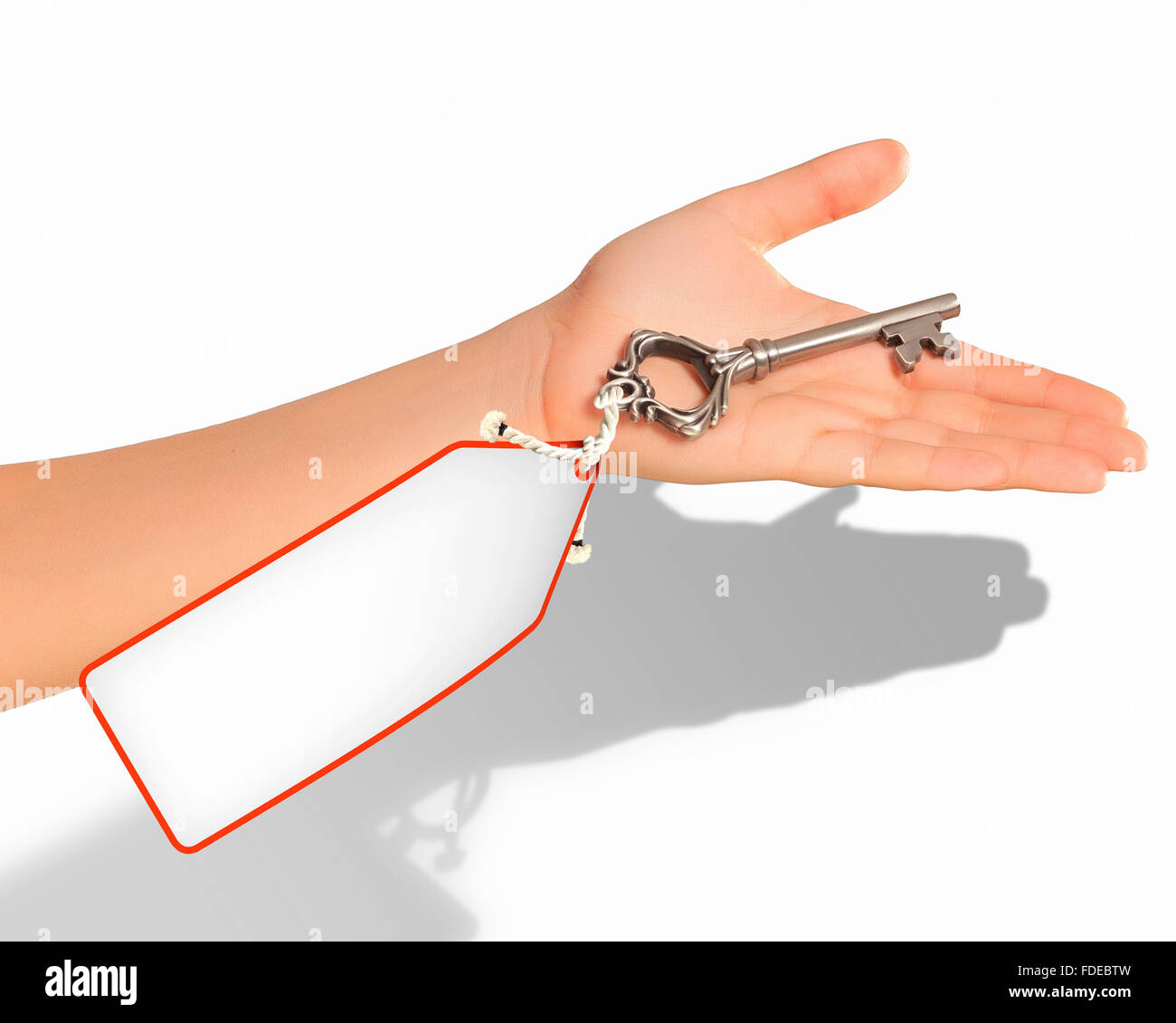 Image of key with blank label in human hand Stock Photo - Alamy