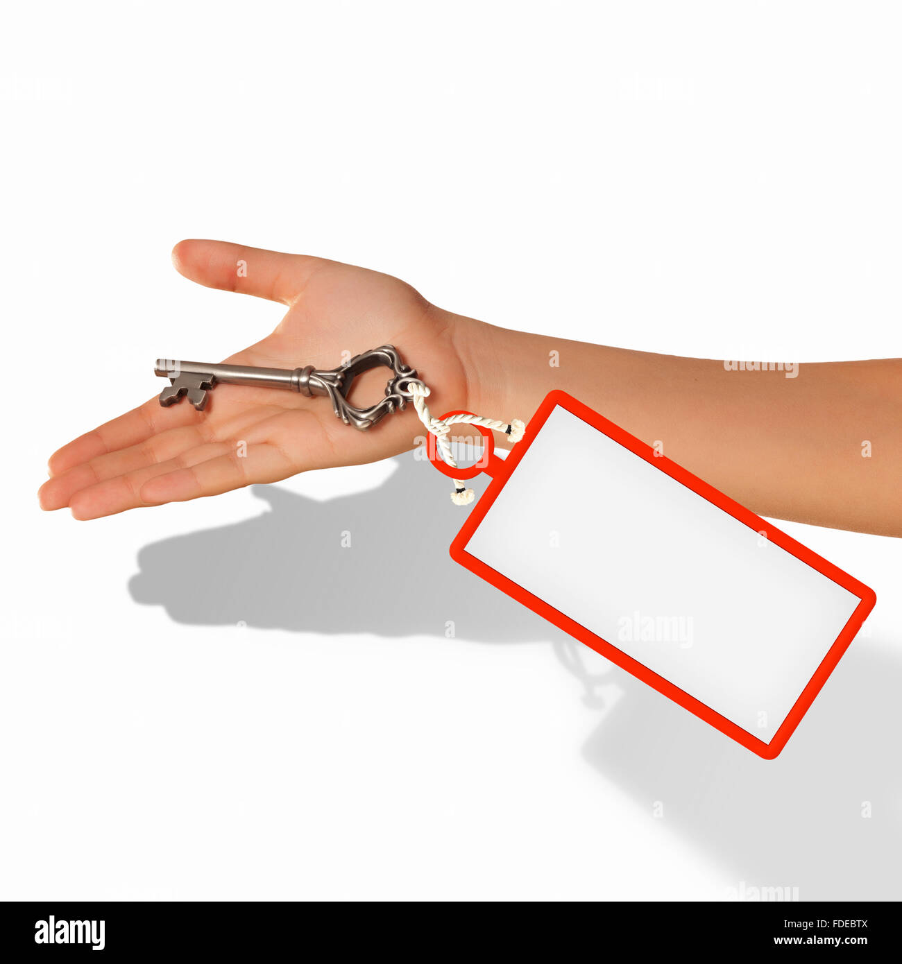 Image of key with blank label in human hand Stock Photo - Alamy