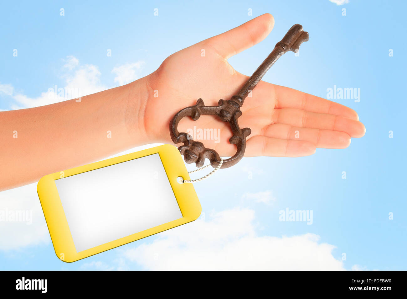 Image of key with blank label in human hand Stock Photo - Alamy