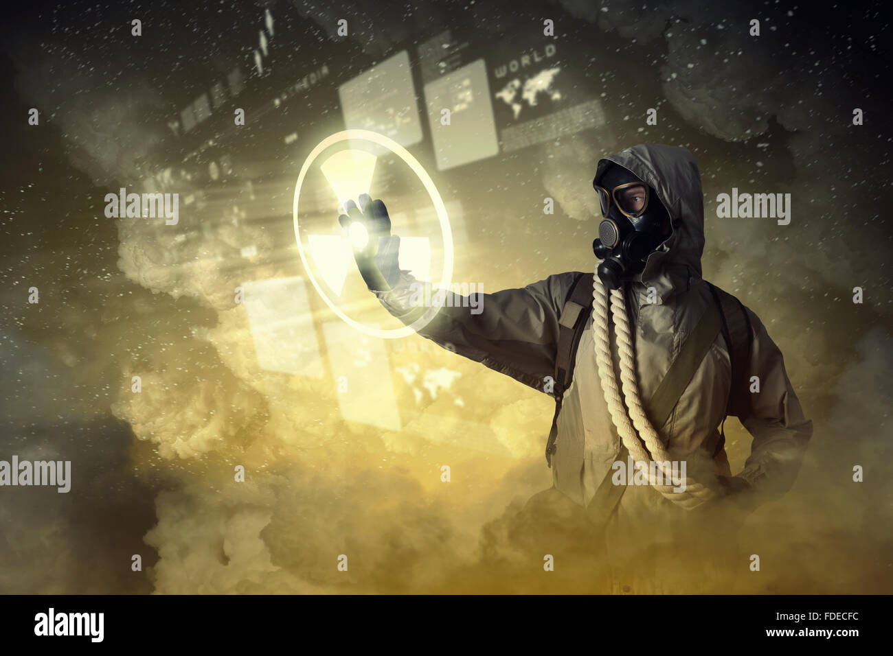 Image of man in gas mask and protective uniform touching radioactivity ...