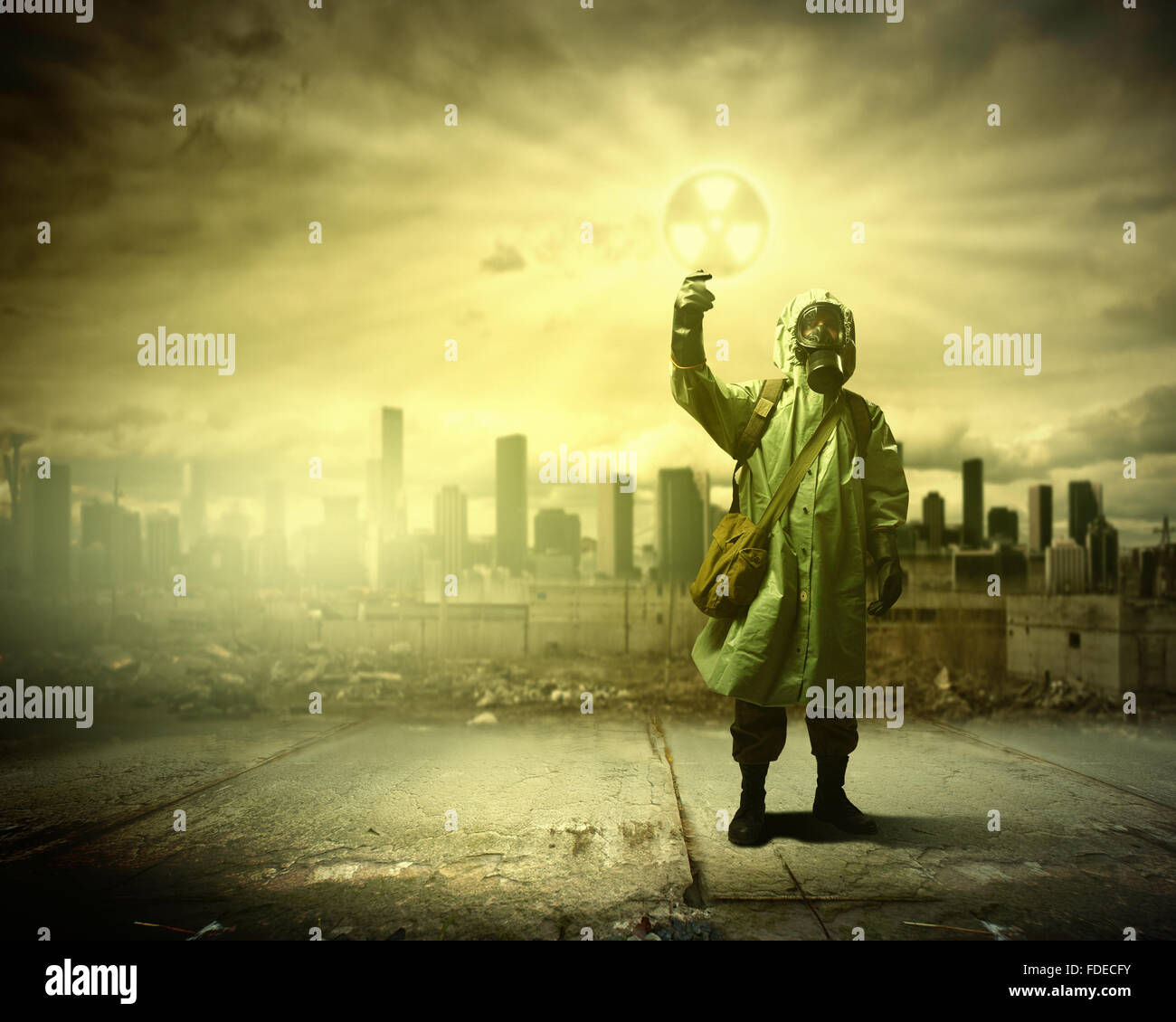 Image of man in gas mask and protective uniform touching radioactivity ...