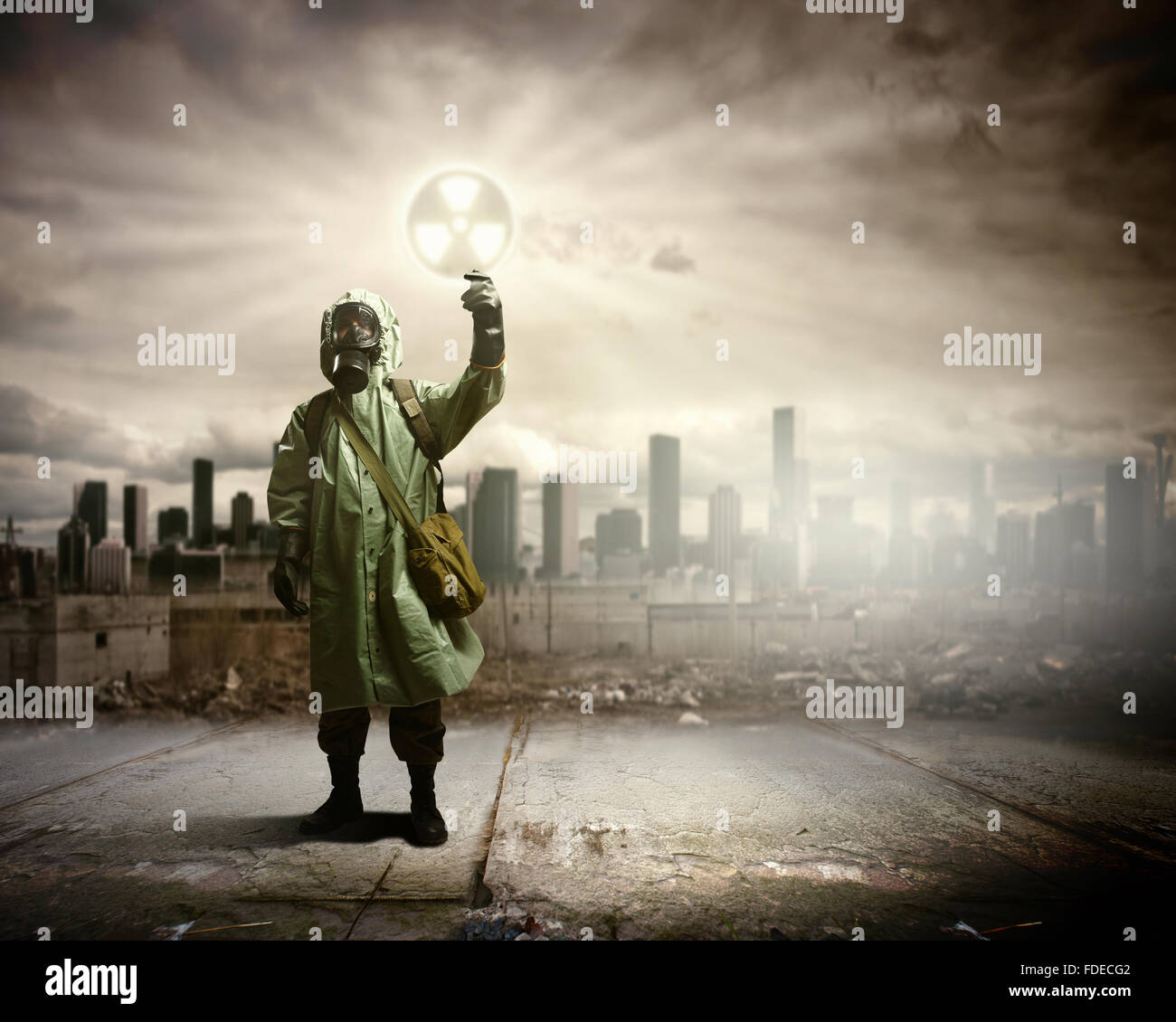 Image of man in gas mask and protective uniform touching radioactivity ...