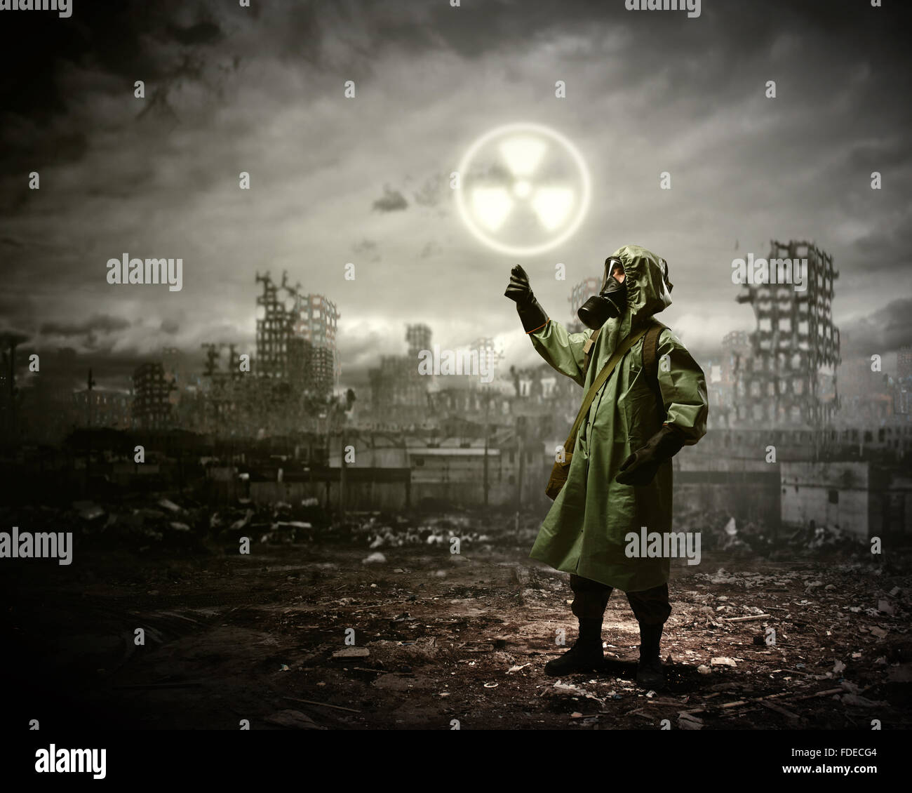 Image of man in gas mask and protective uniform touching radioactivity ...