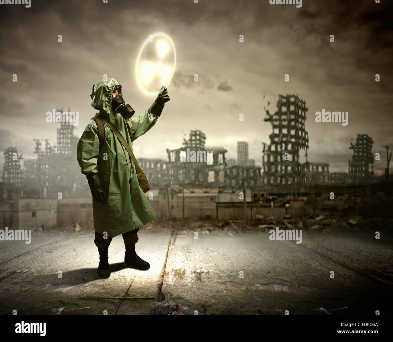 Image of man in gas mask and protective uniform touching radioactivity ...