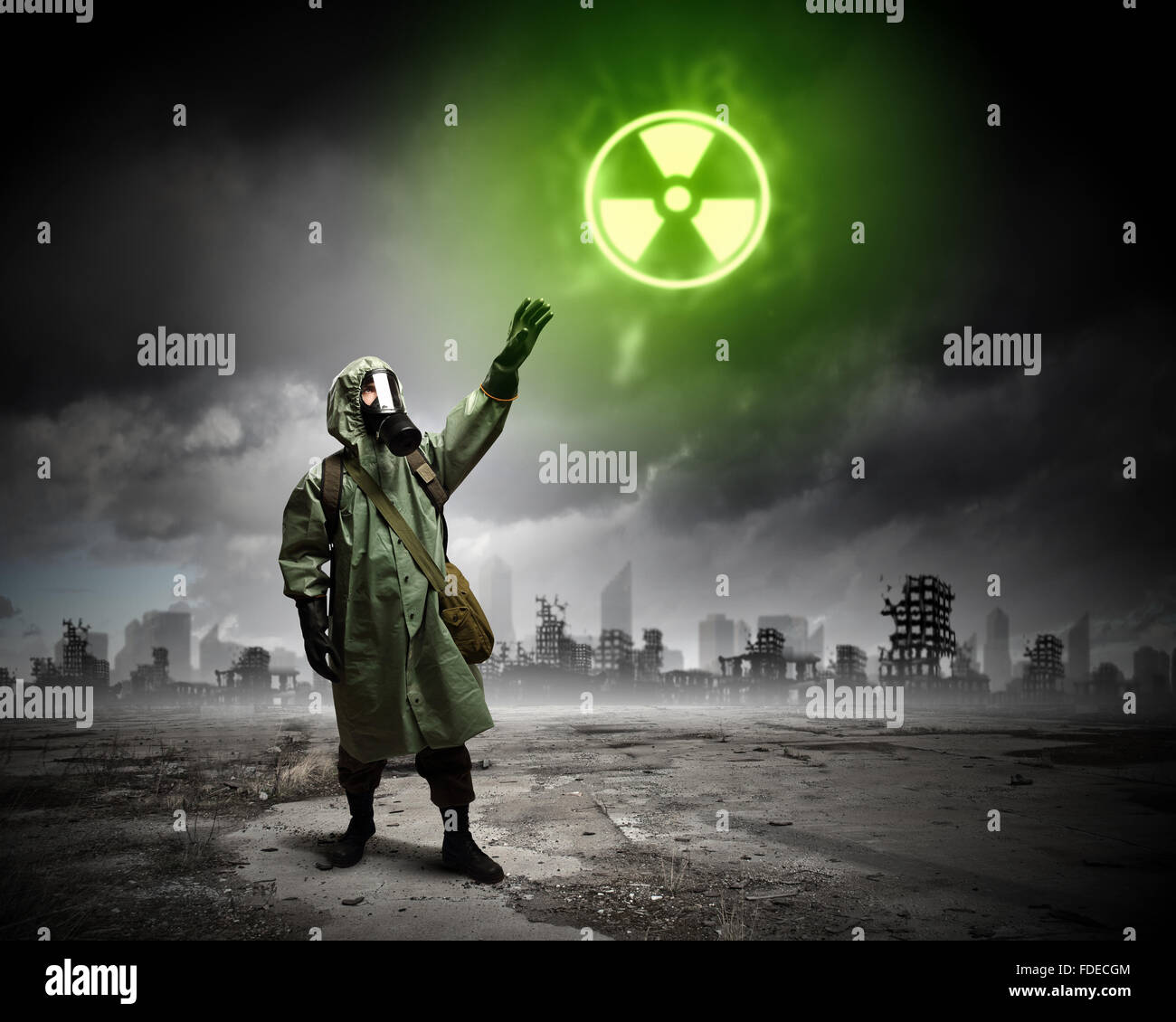 Image of man in gas mask and protective uniform touching radioactivity ...