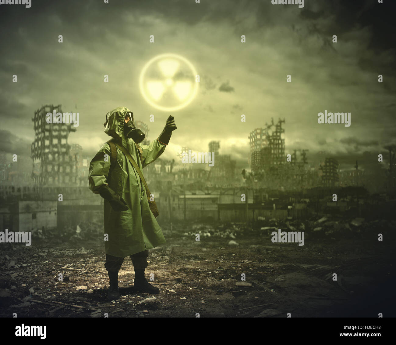 Image of man in gas mask and protective uniform touching radioactivity ...