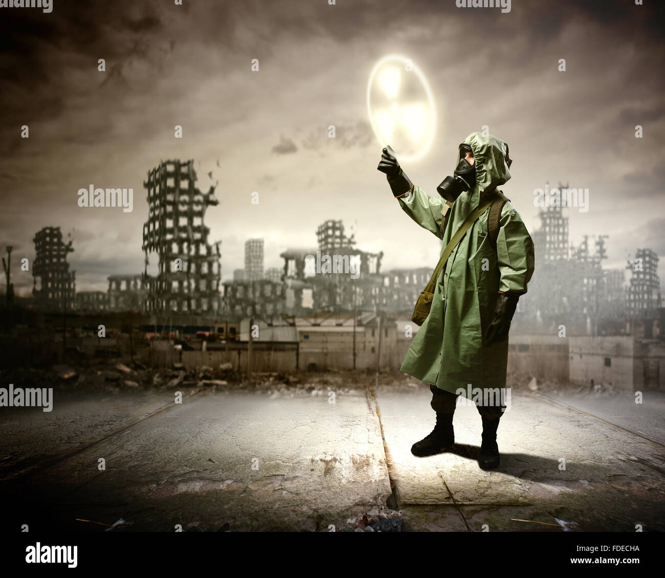 Image of man in gas mask and protective uniform touching radioactivity ...