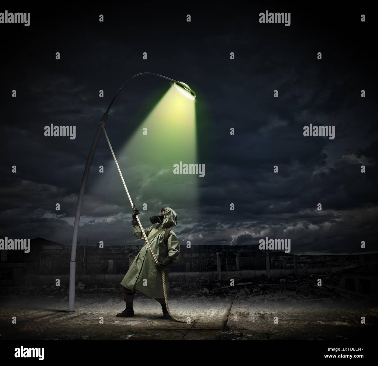 Man in gas mask and camouflage standing under street light Stock Photo ...
