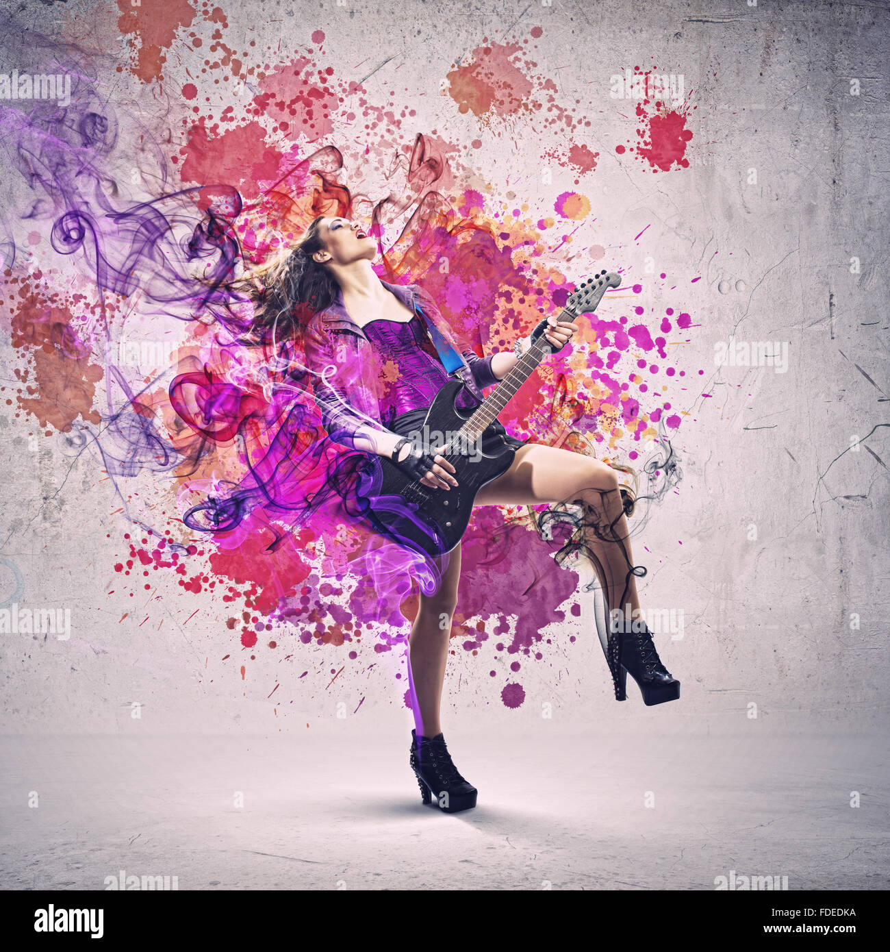 Young attractive rock girl playing the electric guitar Stock Photo - Alamy