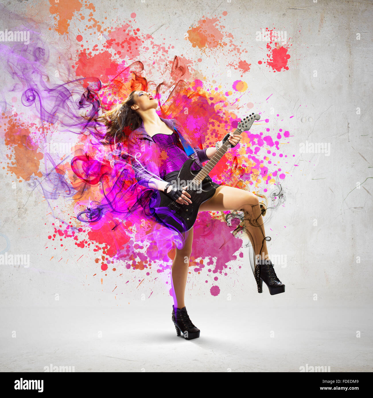 Young attractive rock girl playing the electric guitar Stock Photo - Alamy