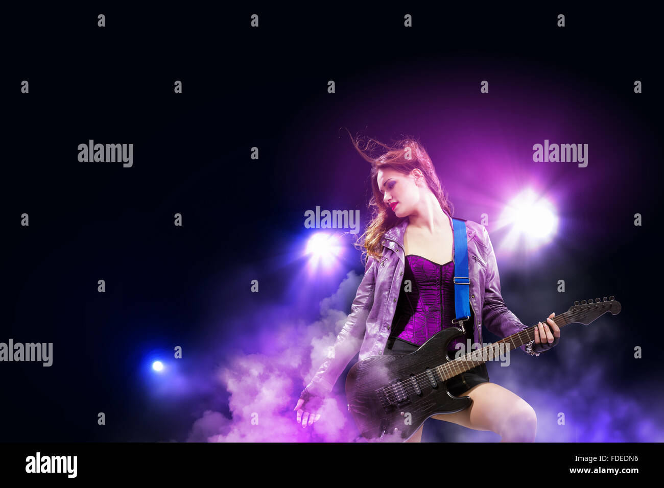 Young attractive rock girl playing the electric guitar Stock Photo - Alamy