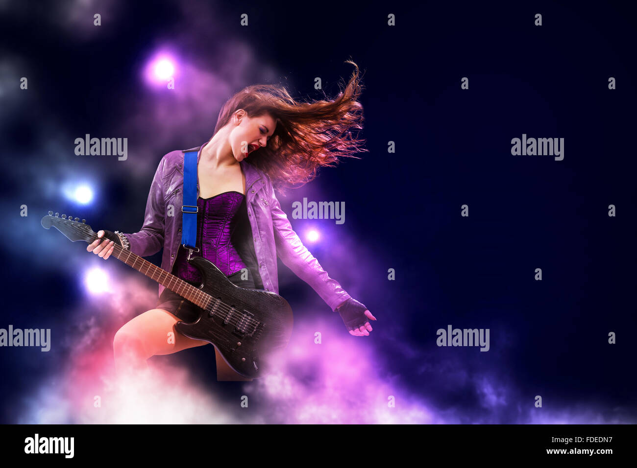 Young attractive rock girl playing the electric guitar Stock Photo - Alamy