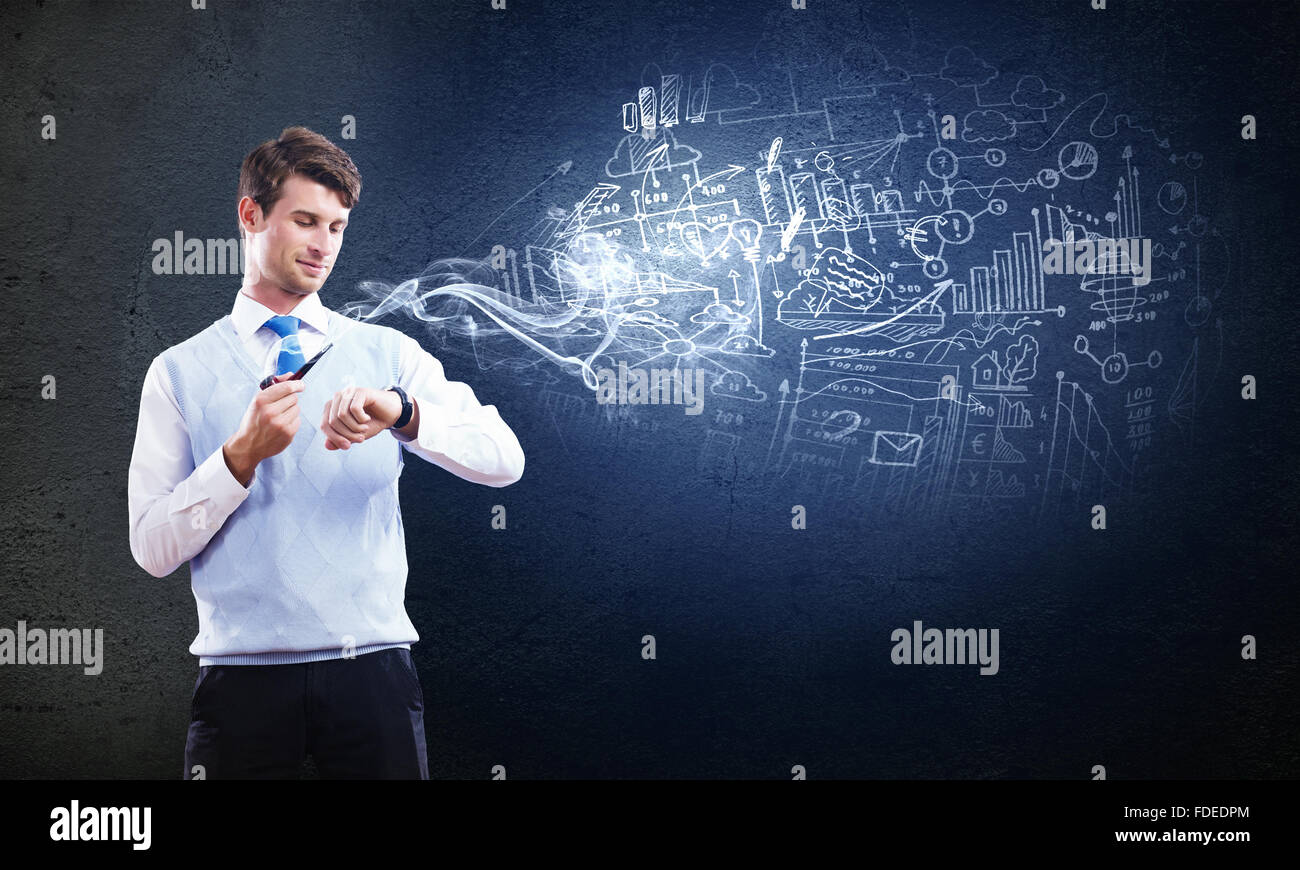 Young businessman smoking pipe with diagrams and graphs at background ...