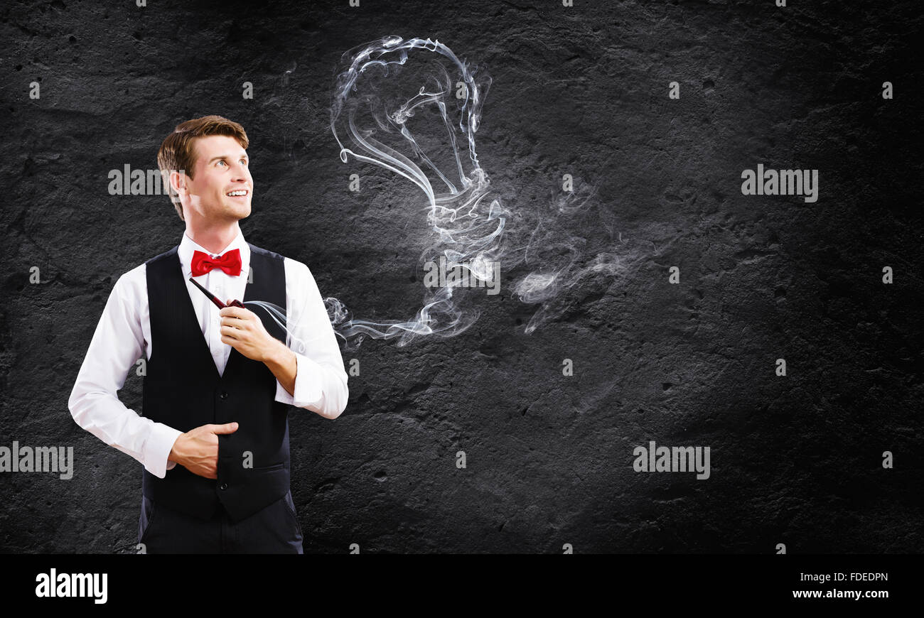 Young handsome businessman in fumes smoking pipe Stock Photo - Alamy