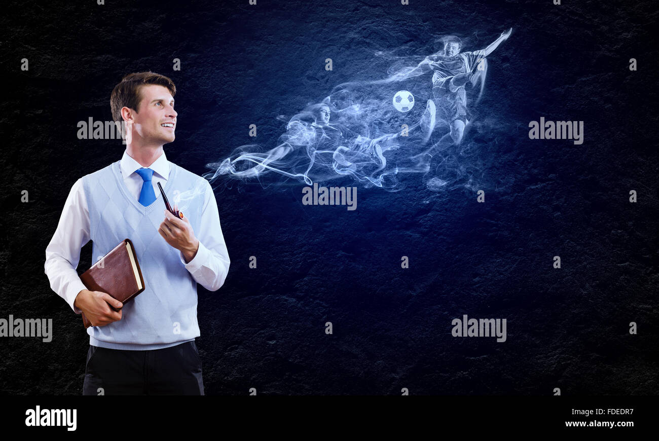 Conceptual image of young handsome man smoking pipe Stock Photo - Alamy