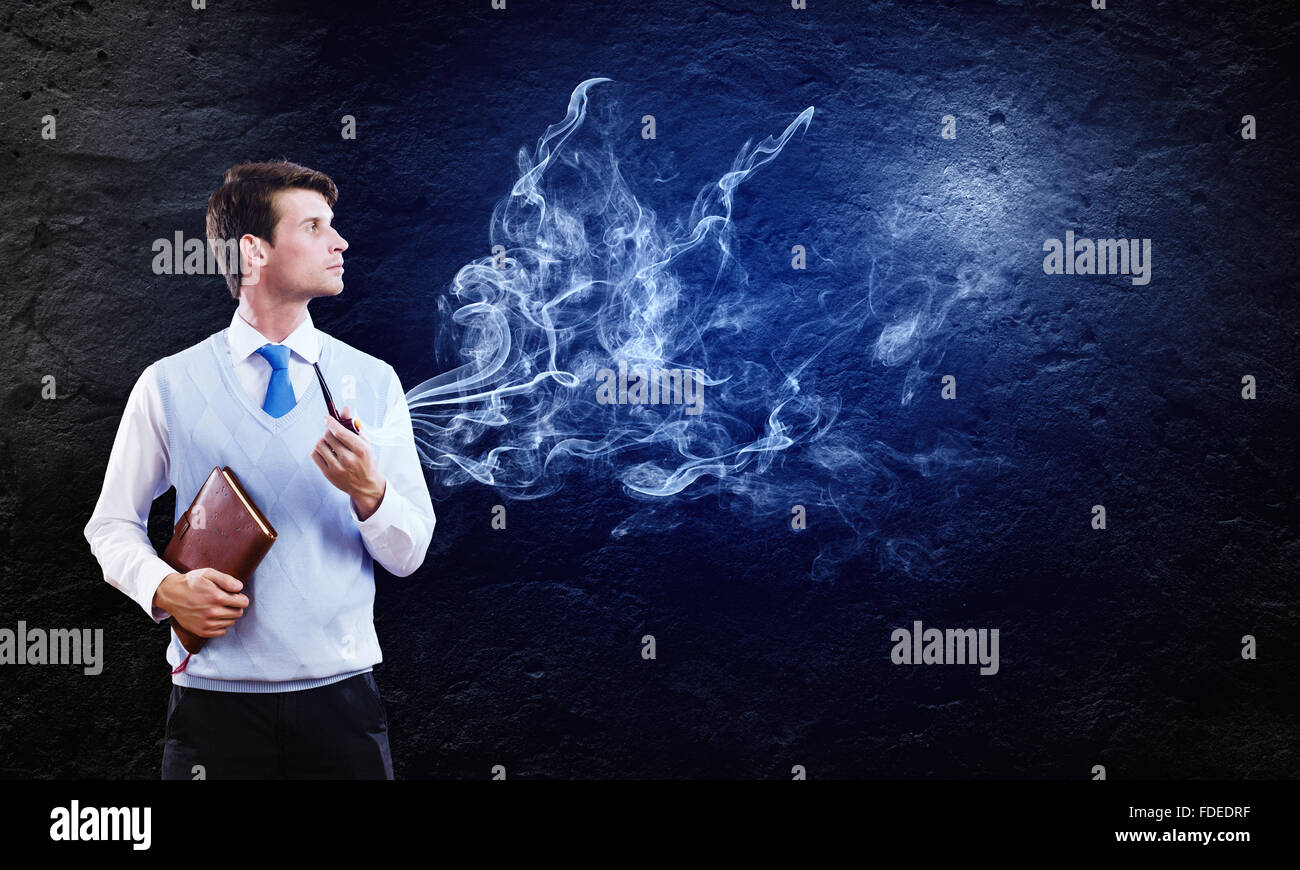 Young handsome businessman smoking pipe against black background Stock ...