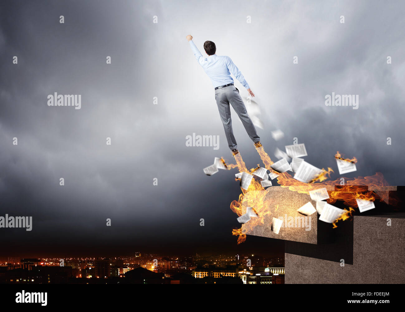 Rear view of businessman superhero flying up in sky Stock Photo - Alamy