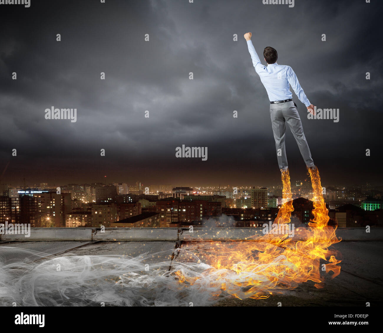 Rear view of businessman superhero flying up in sky Stock Photo - Alamy