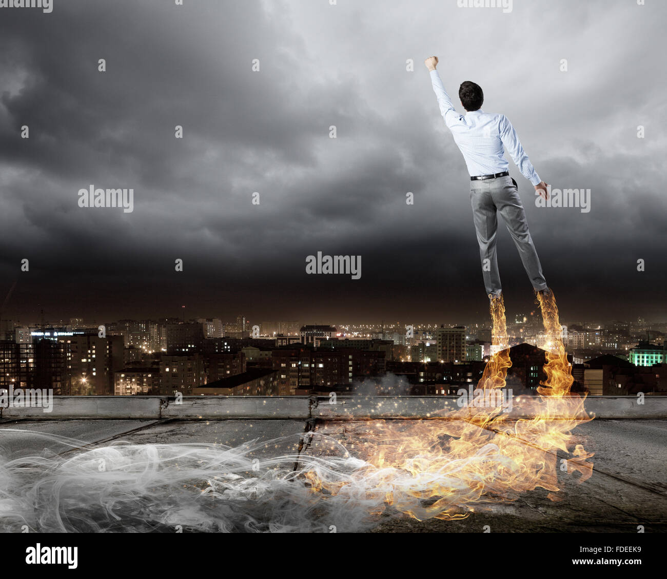 Rear view of businessman superhero flying up in sky Stock Photo - Alamy