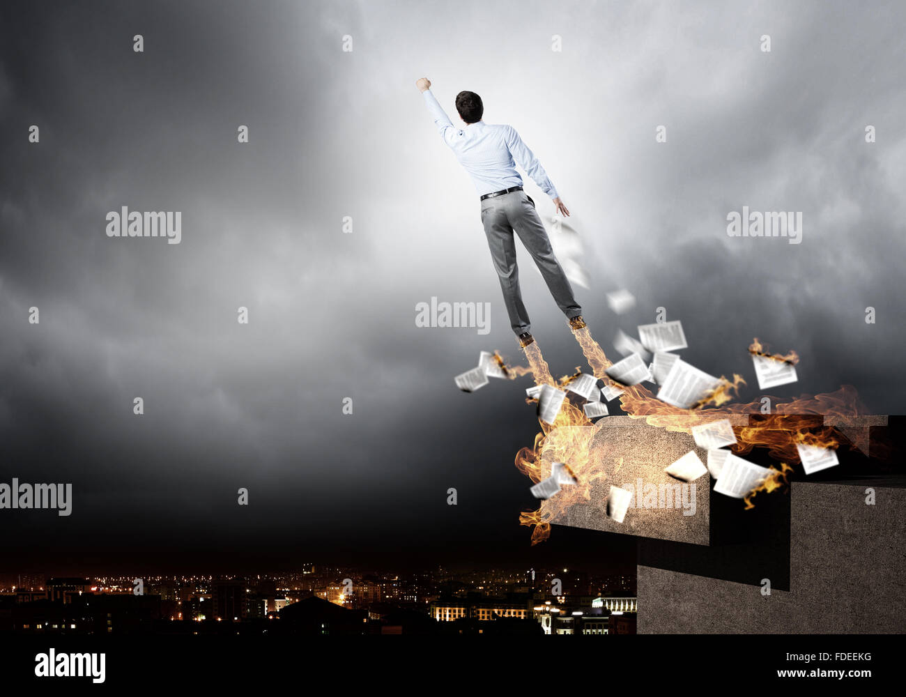 Rear view of businessman superhero flying up in sky Stock Photo - Alamy