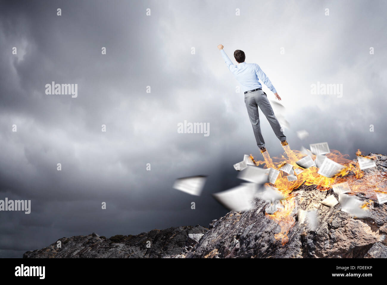 Rear view of businessman superhero flying up in sky Stock Photo - Alamy