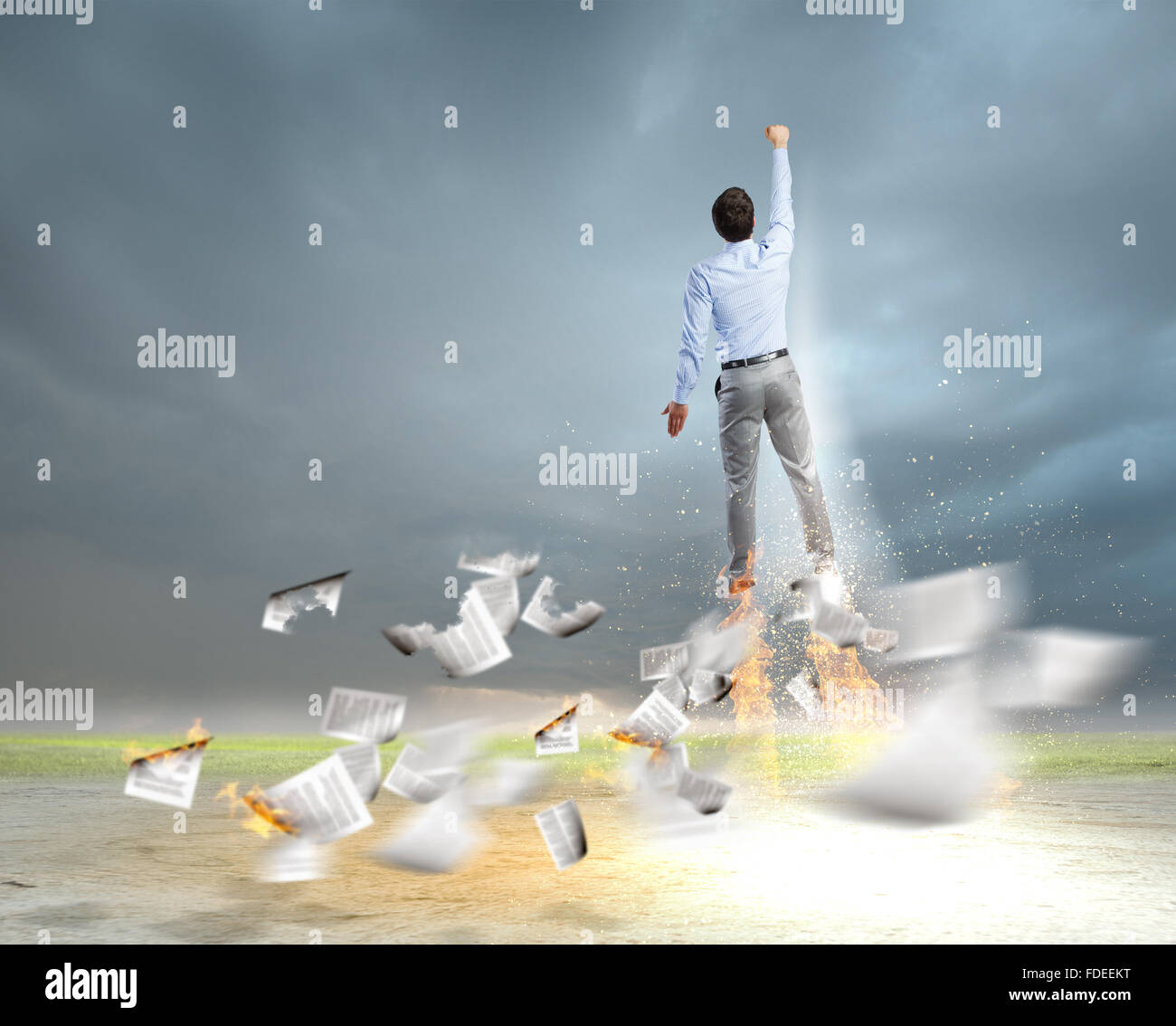 Rear view of businessman superhero flying up in sky Stock Photo - Alamy