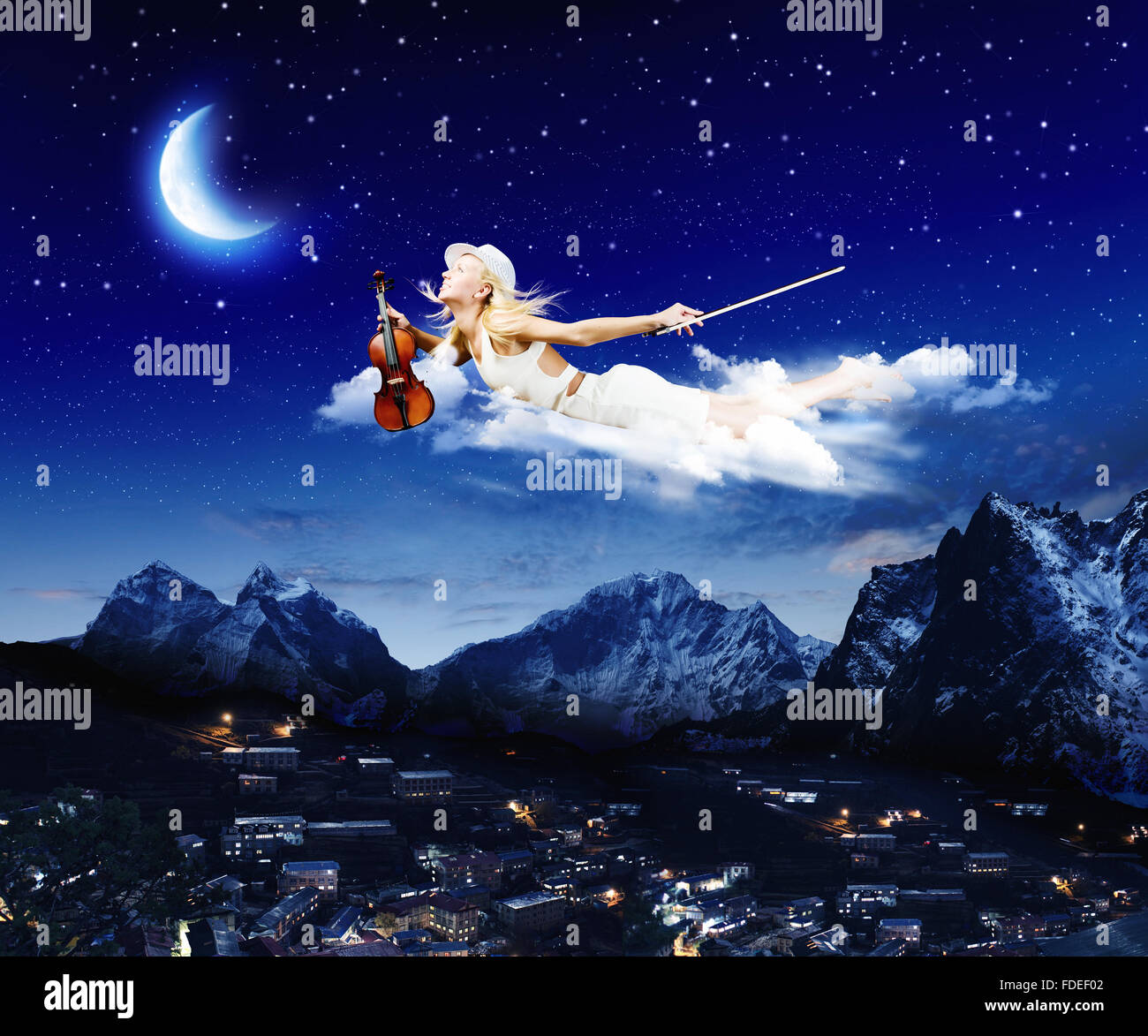 Young blond girl flying in night sky Stock Photo - Alamy