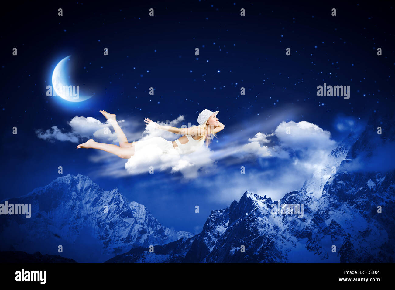 Young blond girl flying in night sky Stock Photo - Alamy