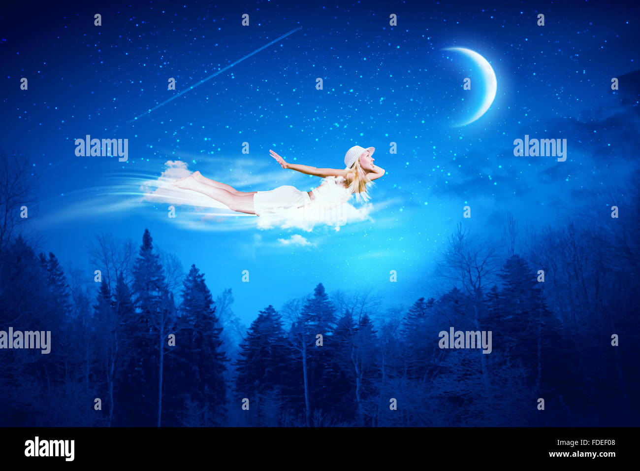 Young blond girl flying in night sky Stock Photo - Alamy