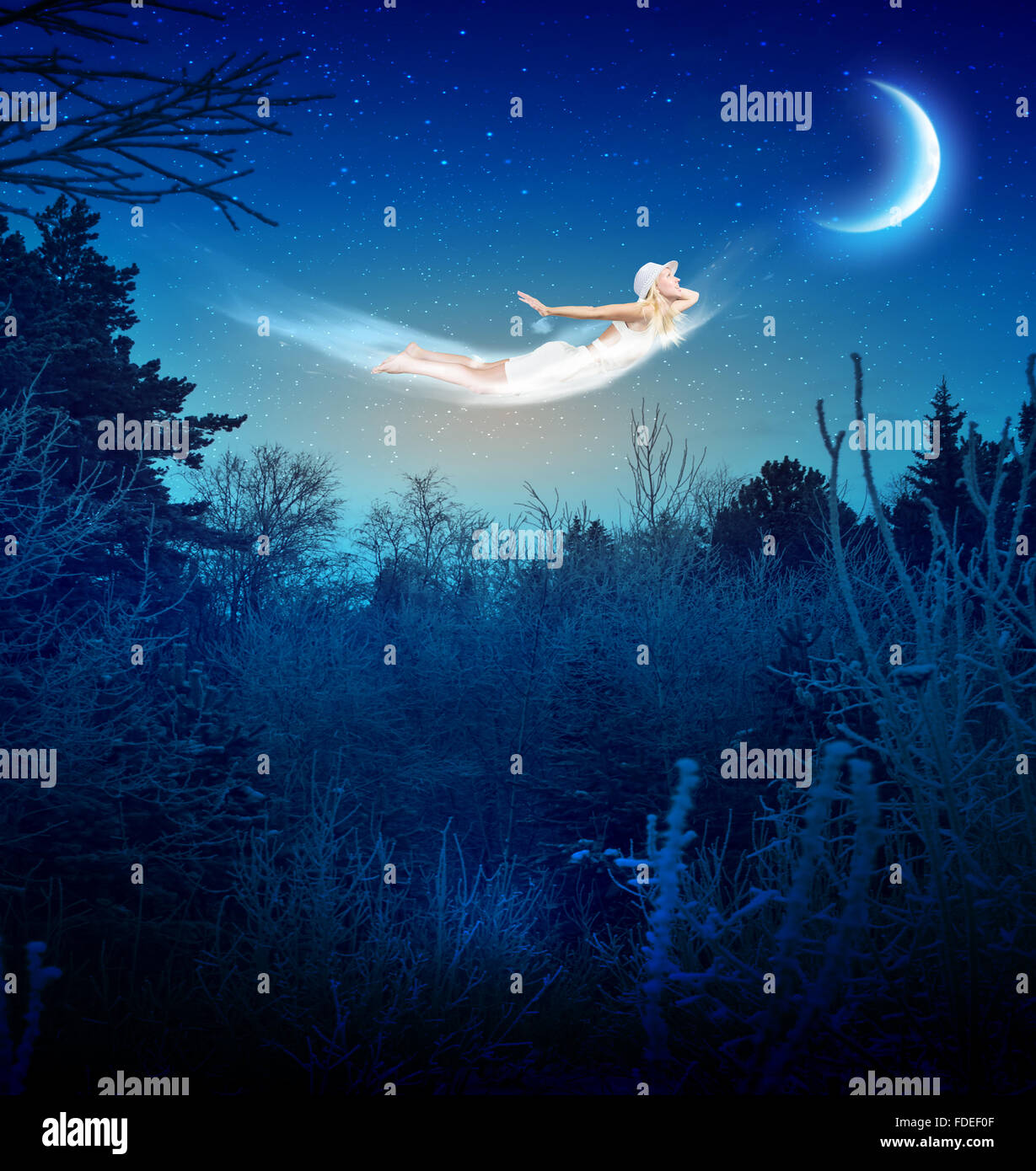 Young blond girl flying in night sky Stock Photo - Alamy