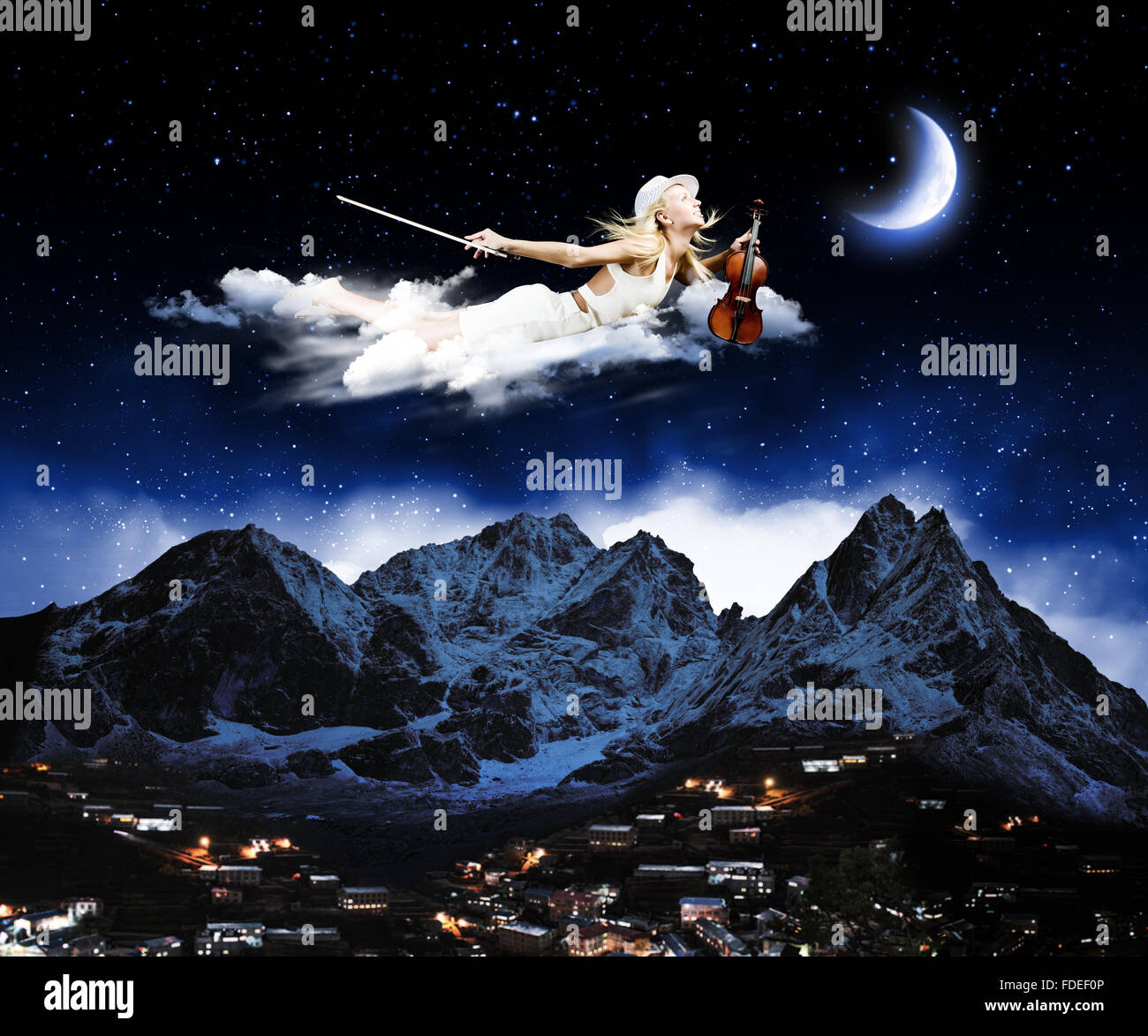 Young blond girl flying in night sky Stock Photo - Alamy