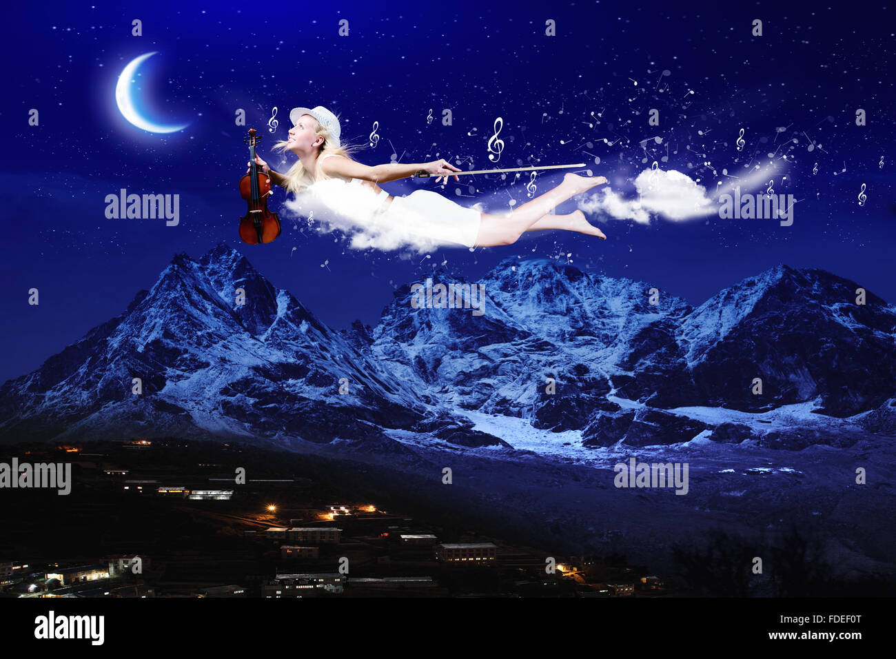 Young blond girl flying in night sky Stock Photo - Alamy