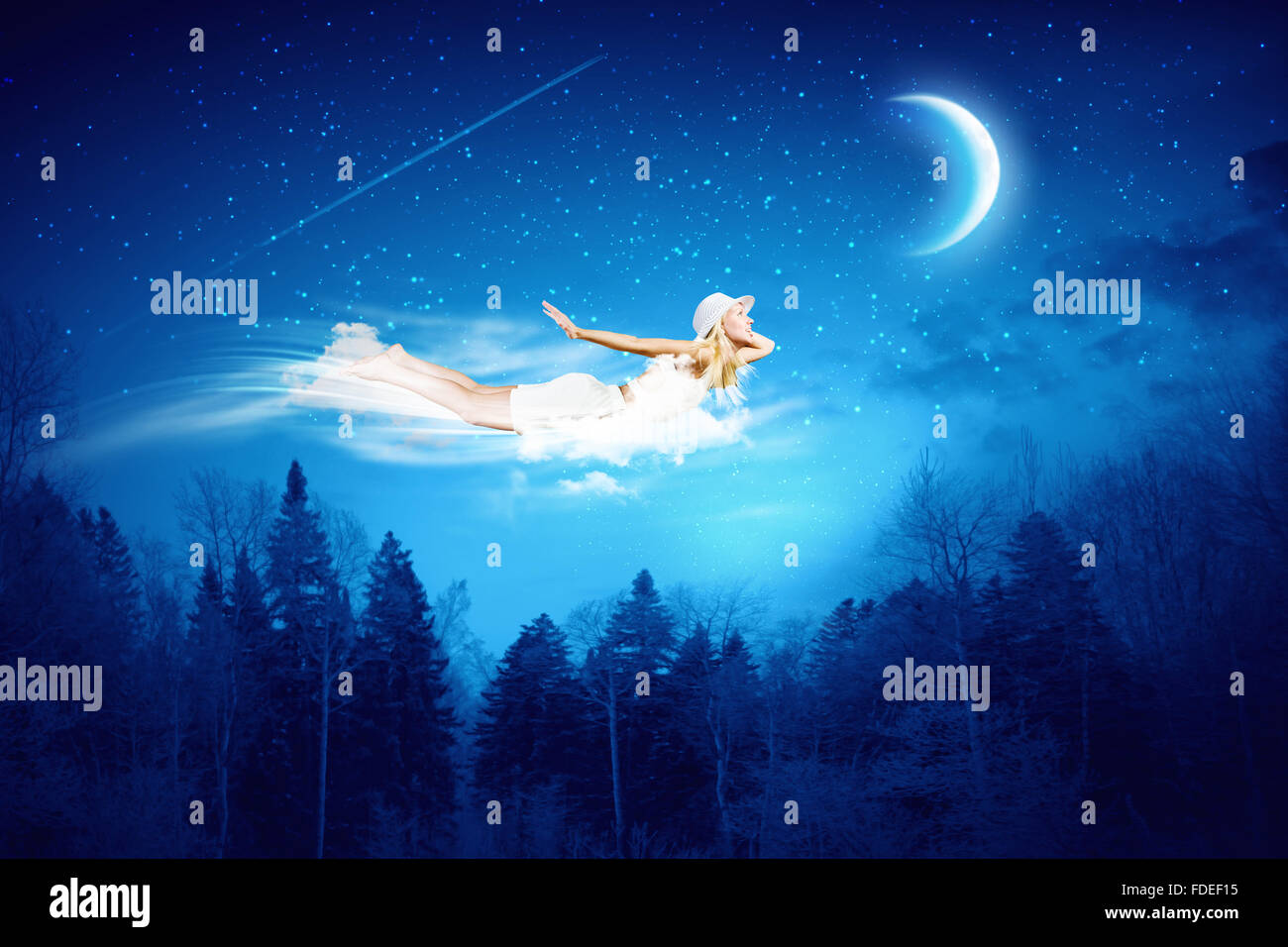 Young blond girl flying in night sky Stock Photo - Alamy