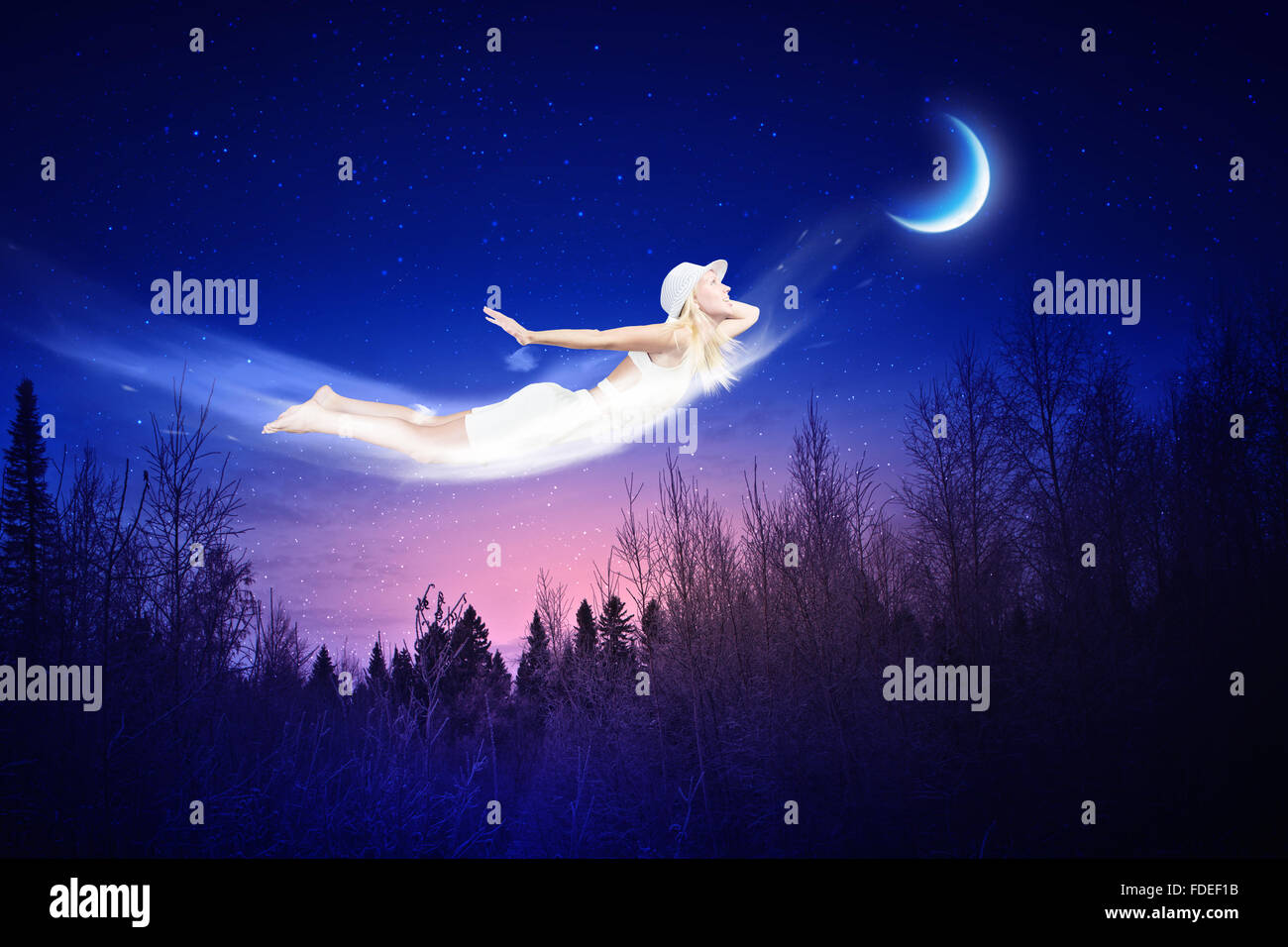 Young blond girl flying in night sky Stock Photo - Alamy