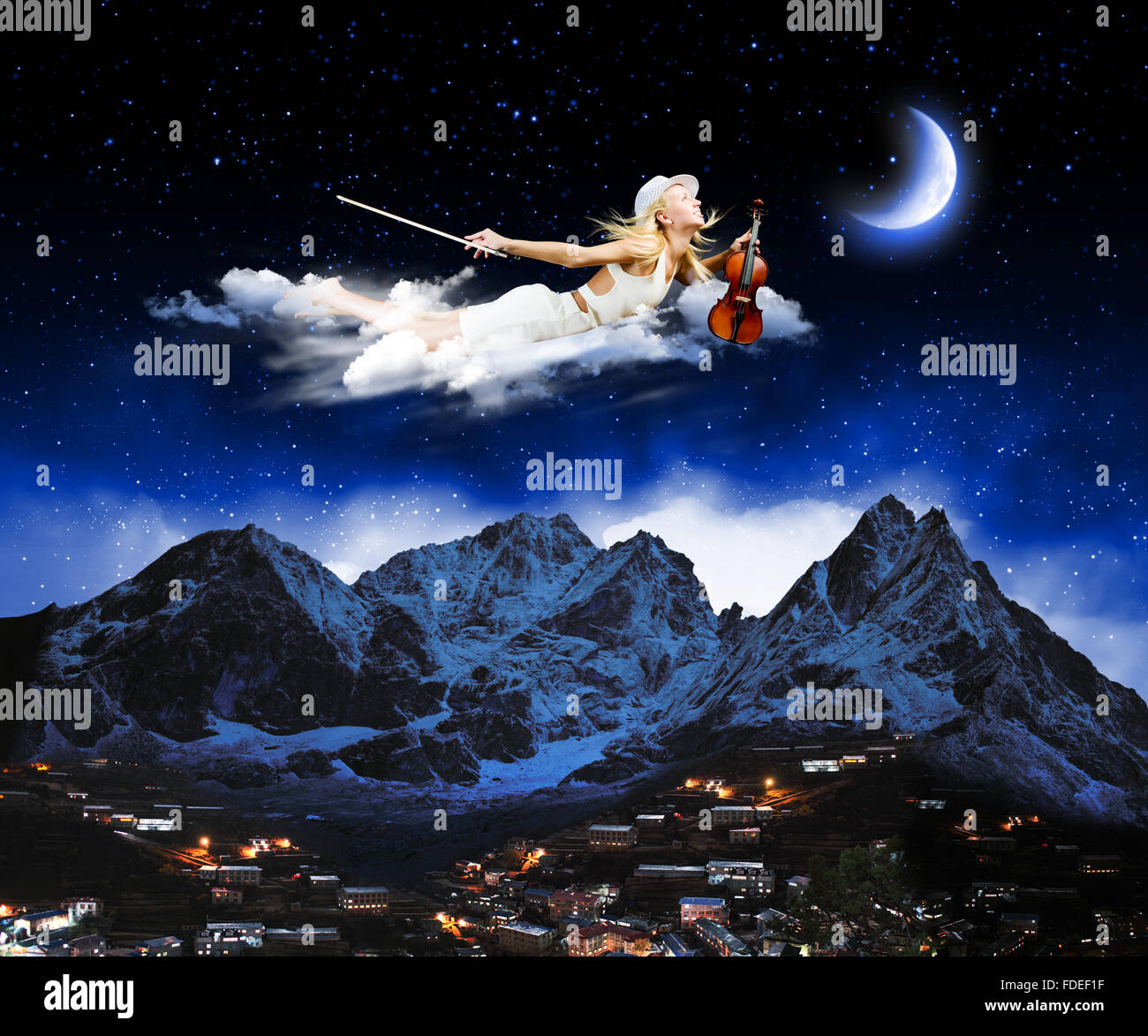Young blond girl flying in night sky Stock Photo - Alamy