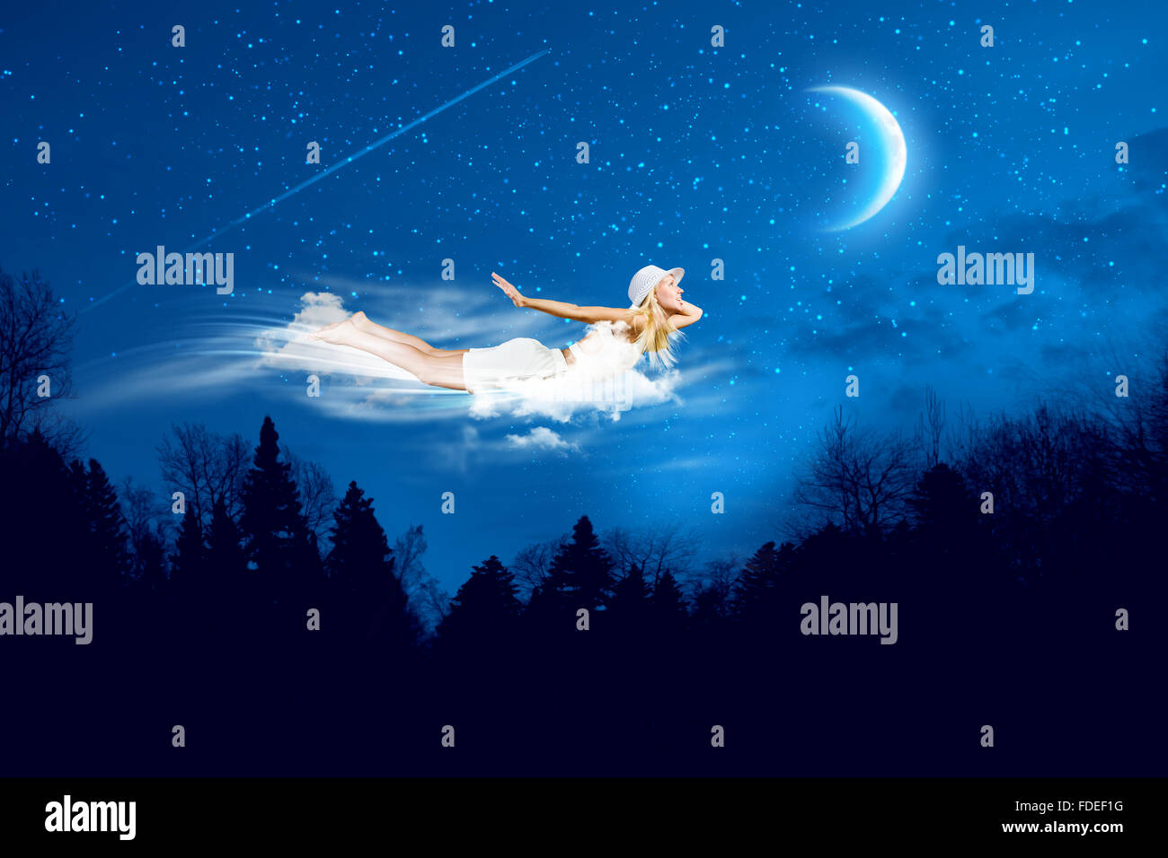 Young blond girl flying in night sky Stock Photo - Alamy