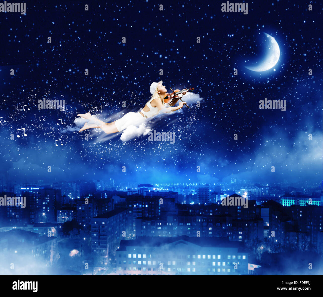 Young blond girl flying in night sky Stock Photo - Alamy