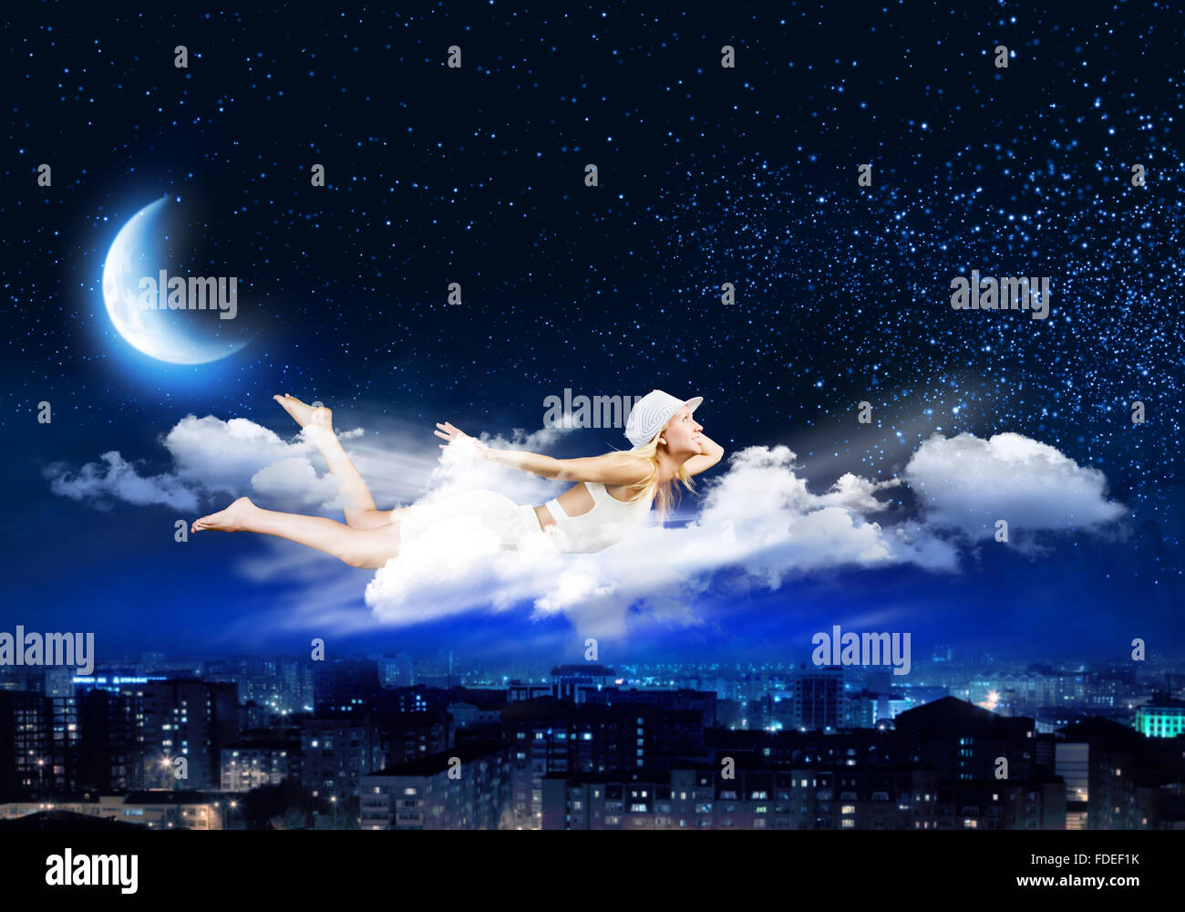 Young blond girl flying in night sky Stock Photo - Alamy