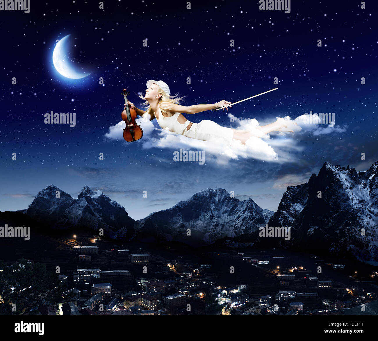 Young blond girl flying in night sky Stock Photo - Alamy