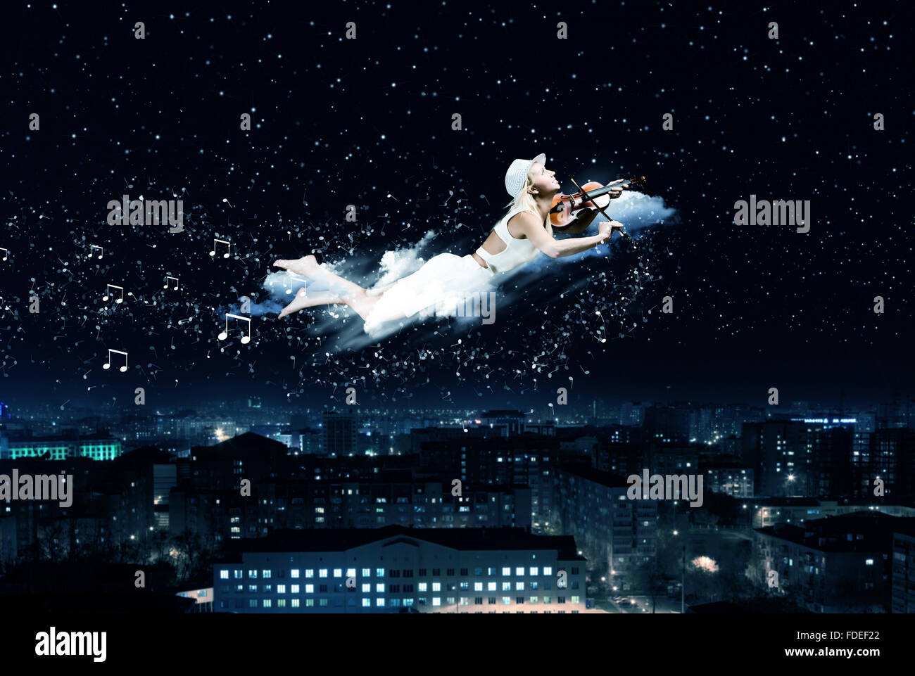 Young blond girl flying in night sky Stock Photo - Alamy