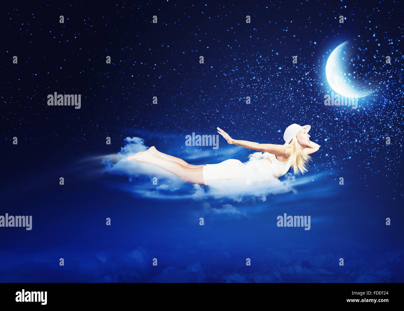 Young blond girl flying in night sky Stock Photo - Alamy