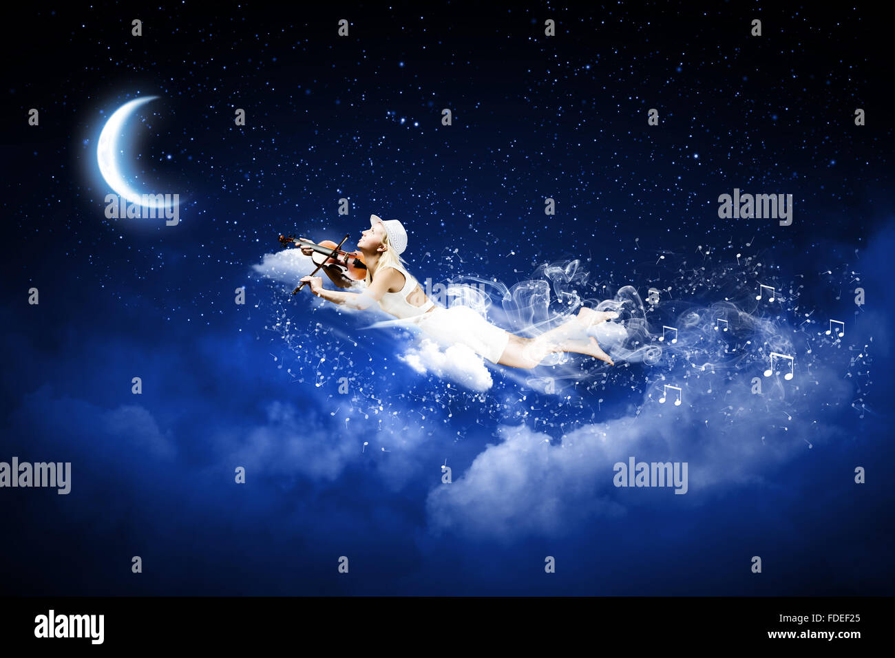 Young blond girl flying in night sky Stock Photo - Alamy