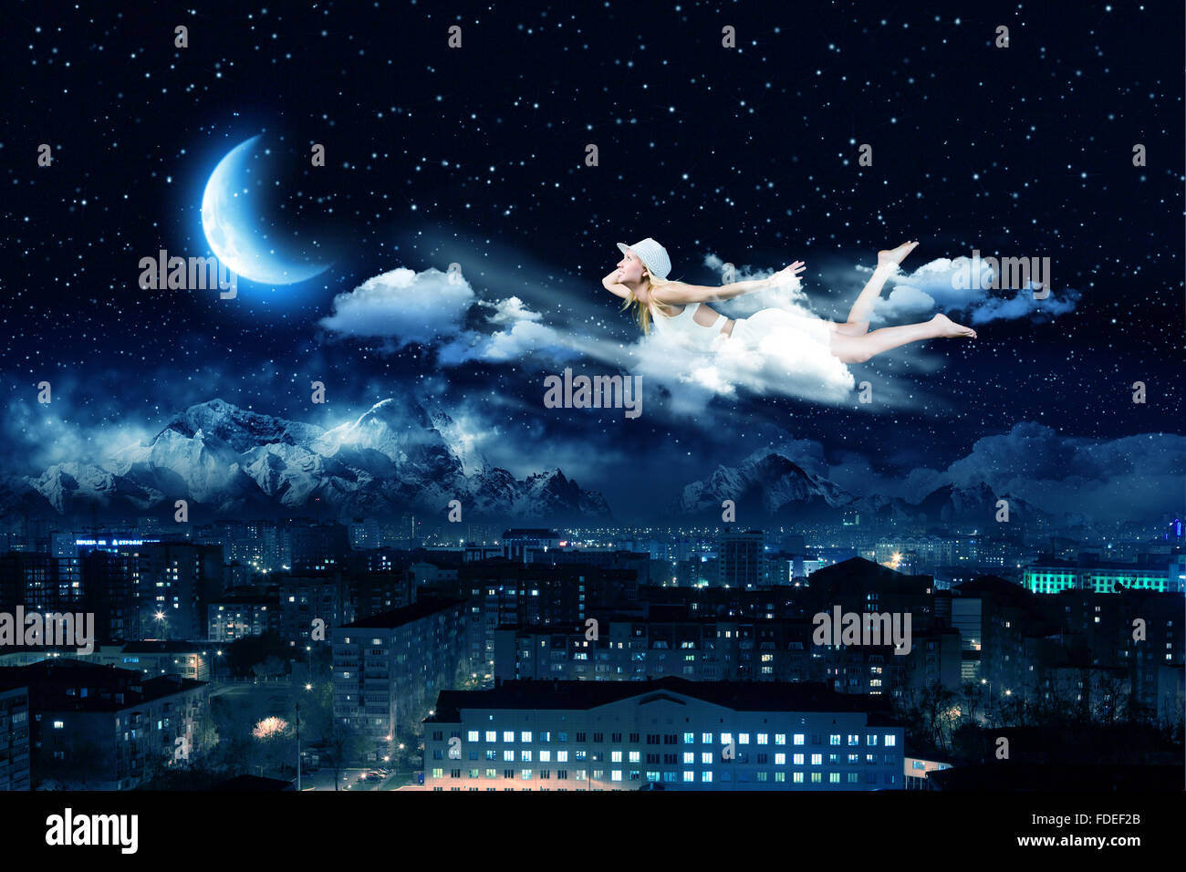 Young blond girl flying in night sky Stock Photo - Alamy