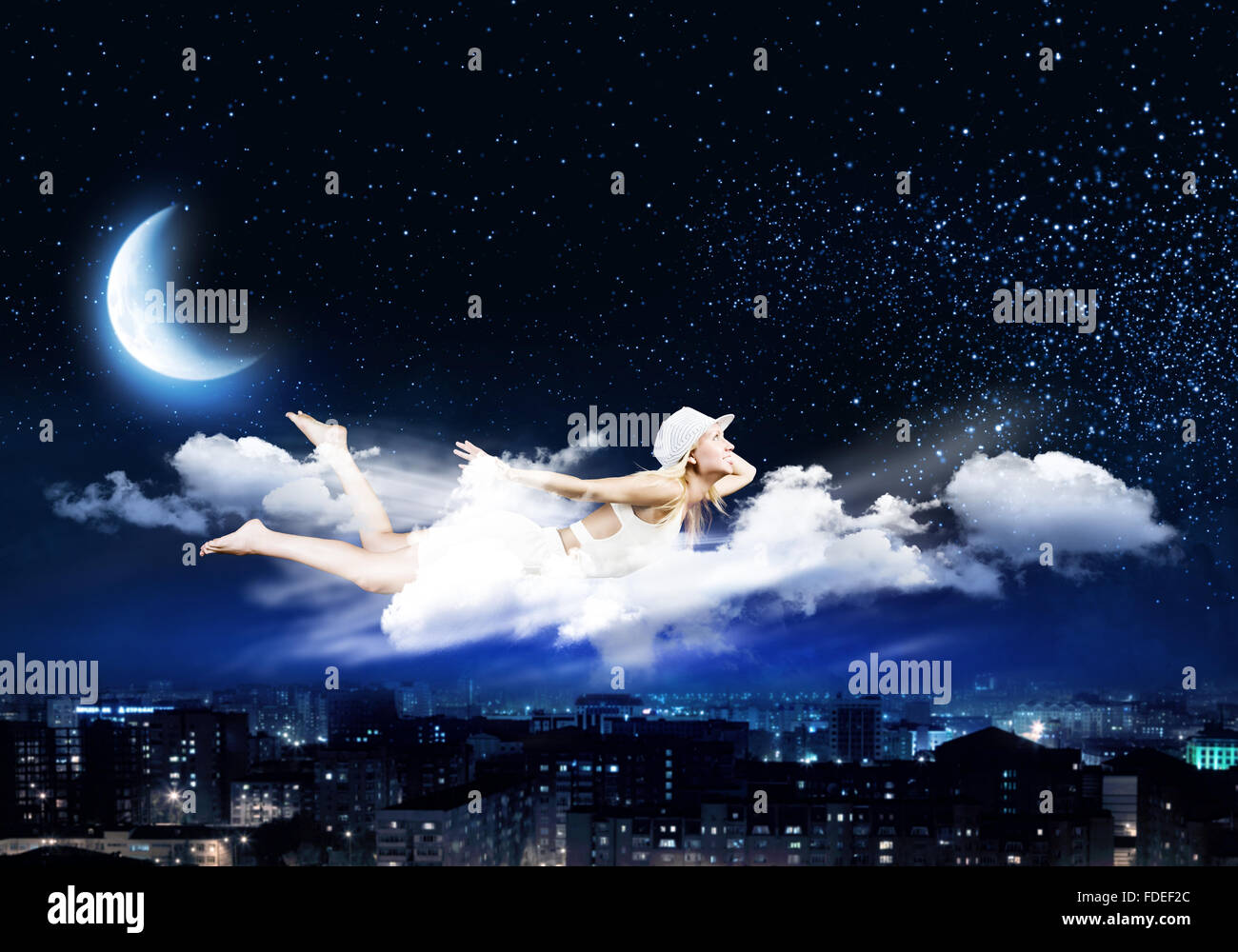 Young blond girl flying in night sky Stock Photo - Alamy