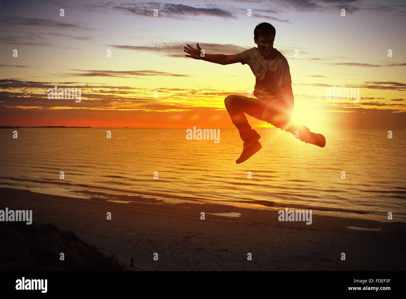 Silhouette of dancer jumping against city in lights of sunrise Stock ...