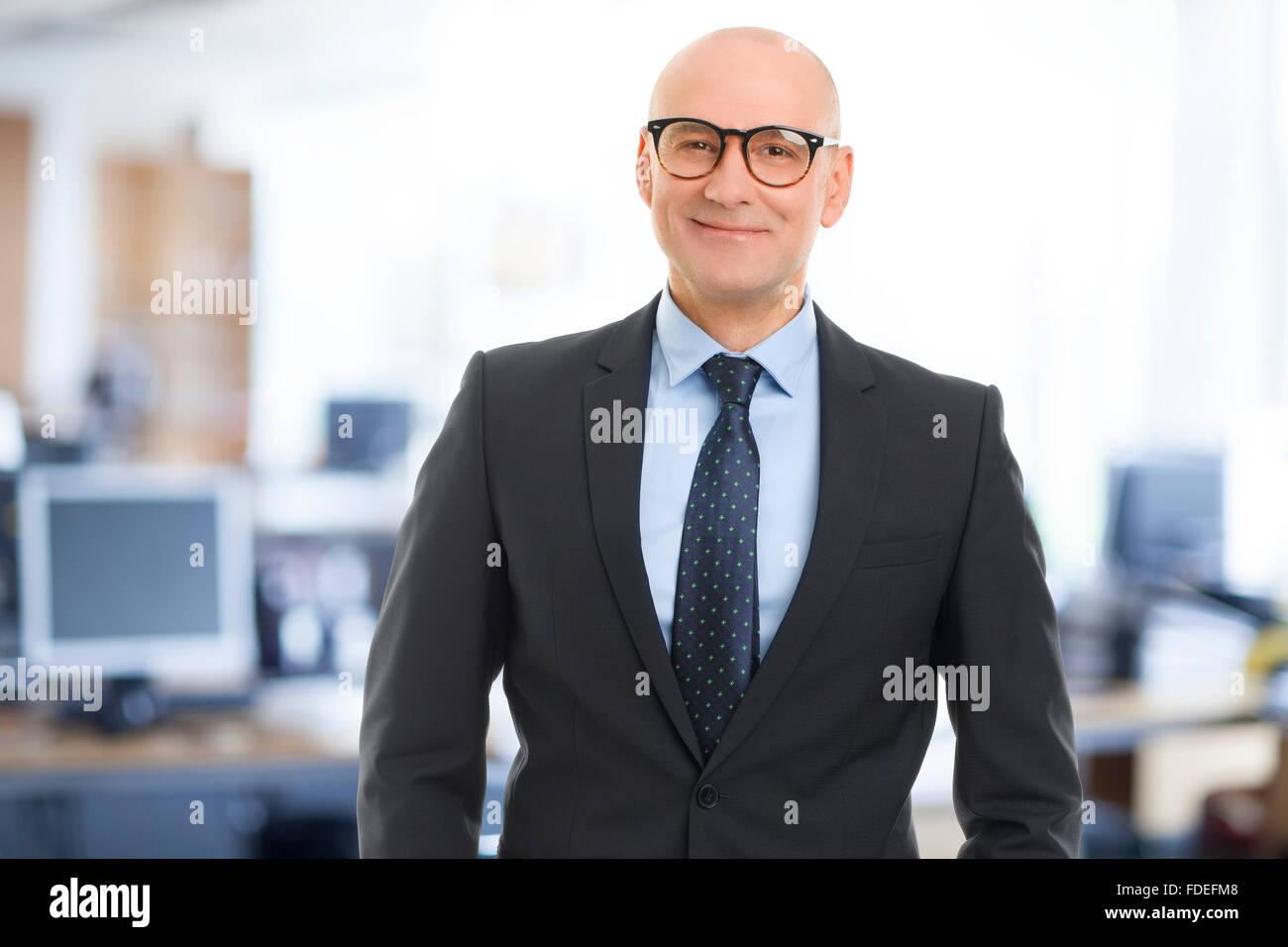 Portrait of successful senior sales man standing at office. Business ...