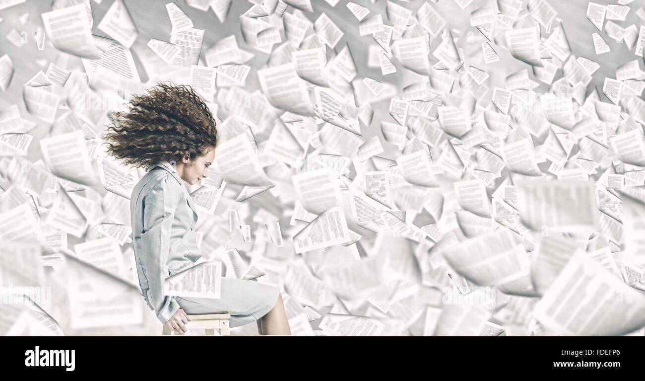 Young tired businesswoman with waving hair among flying documents Stock ...