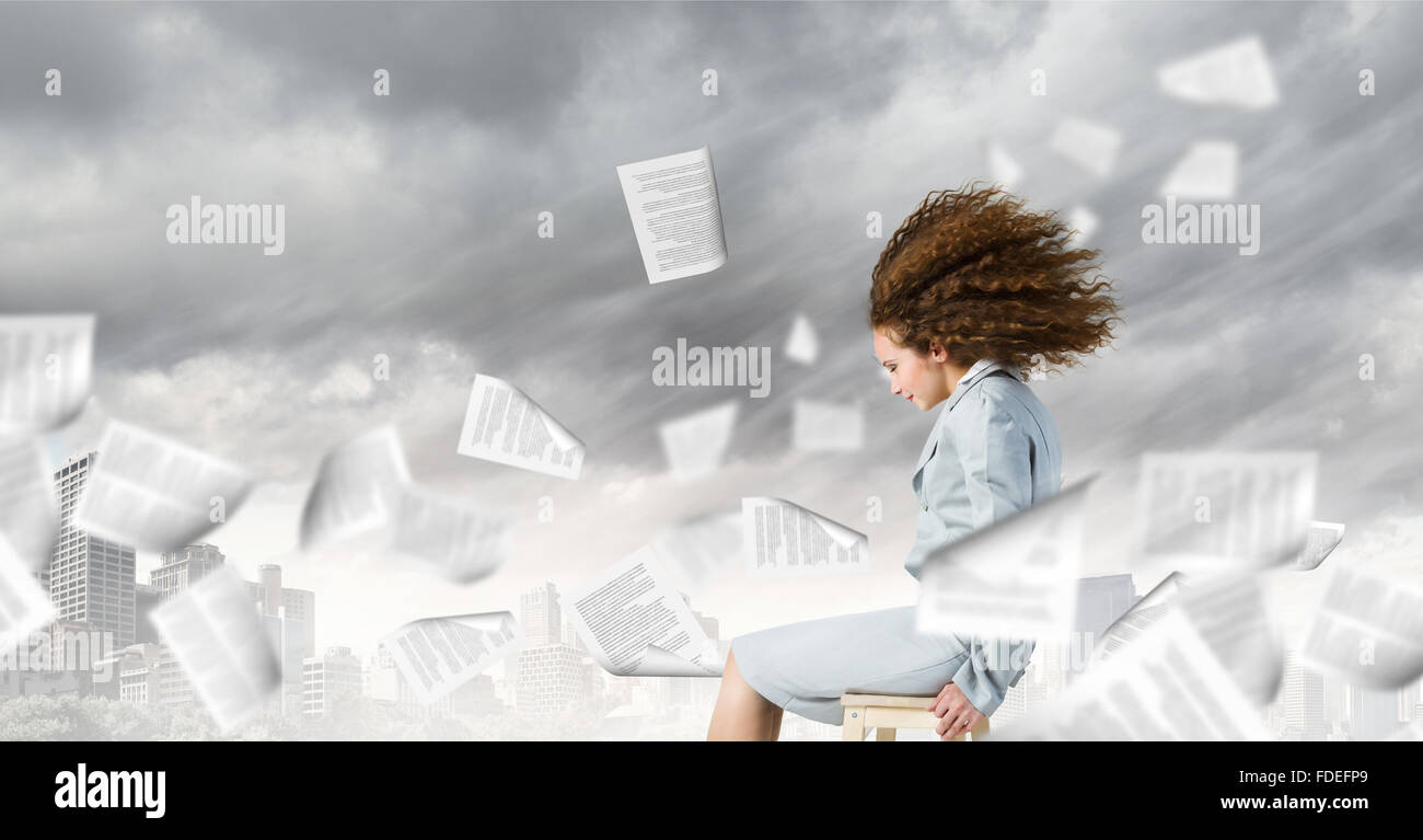 Young tired businesswoman with waving hair among flying documents Stock ...