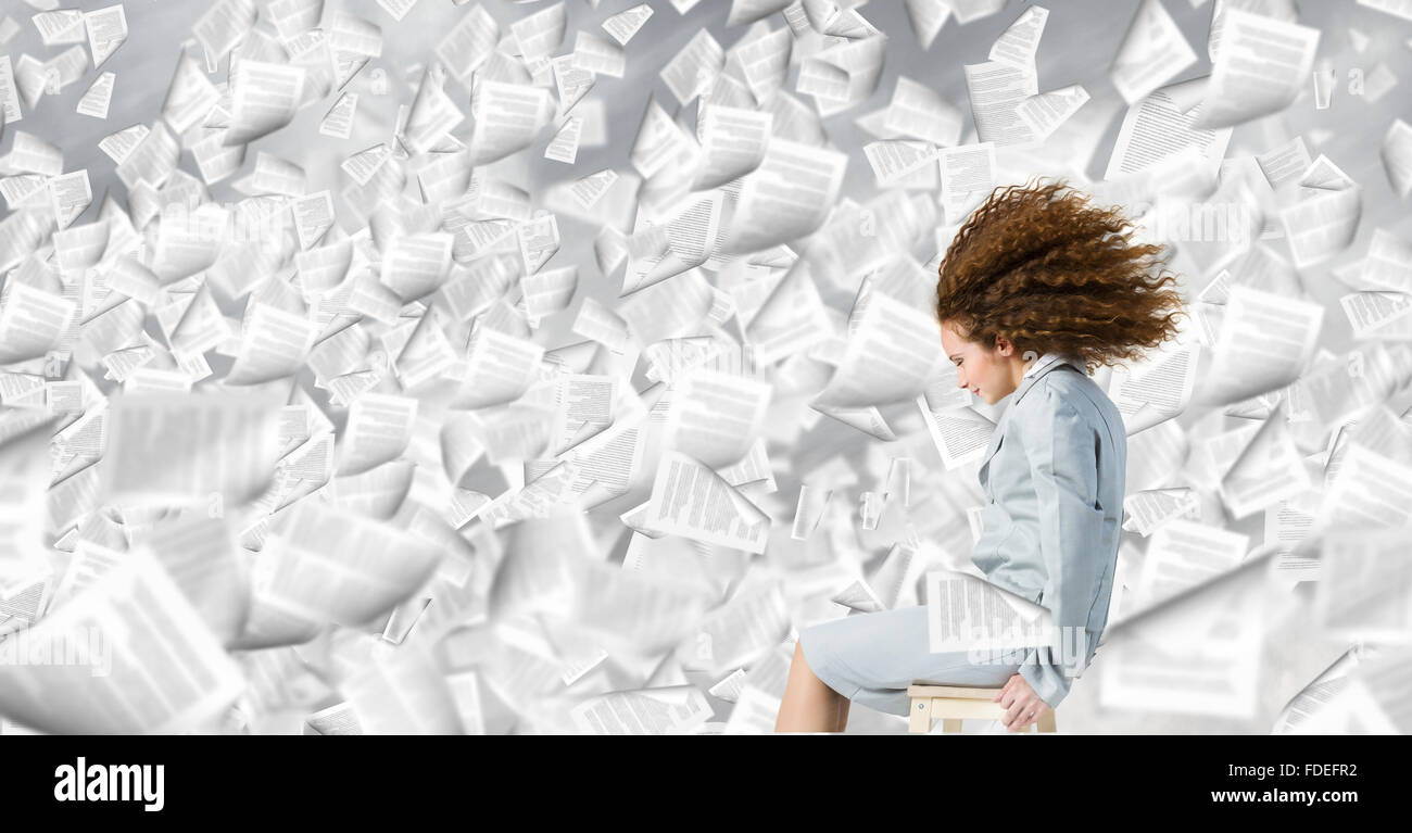 Young tired businesswoman with waving hair among flying documents Stock ...