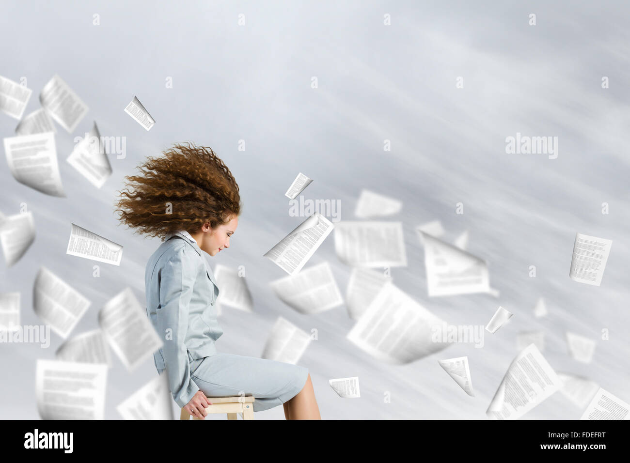 Young tired businesswoman with waving hair among flying documents Stock ...